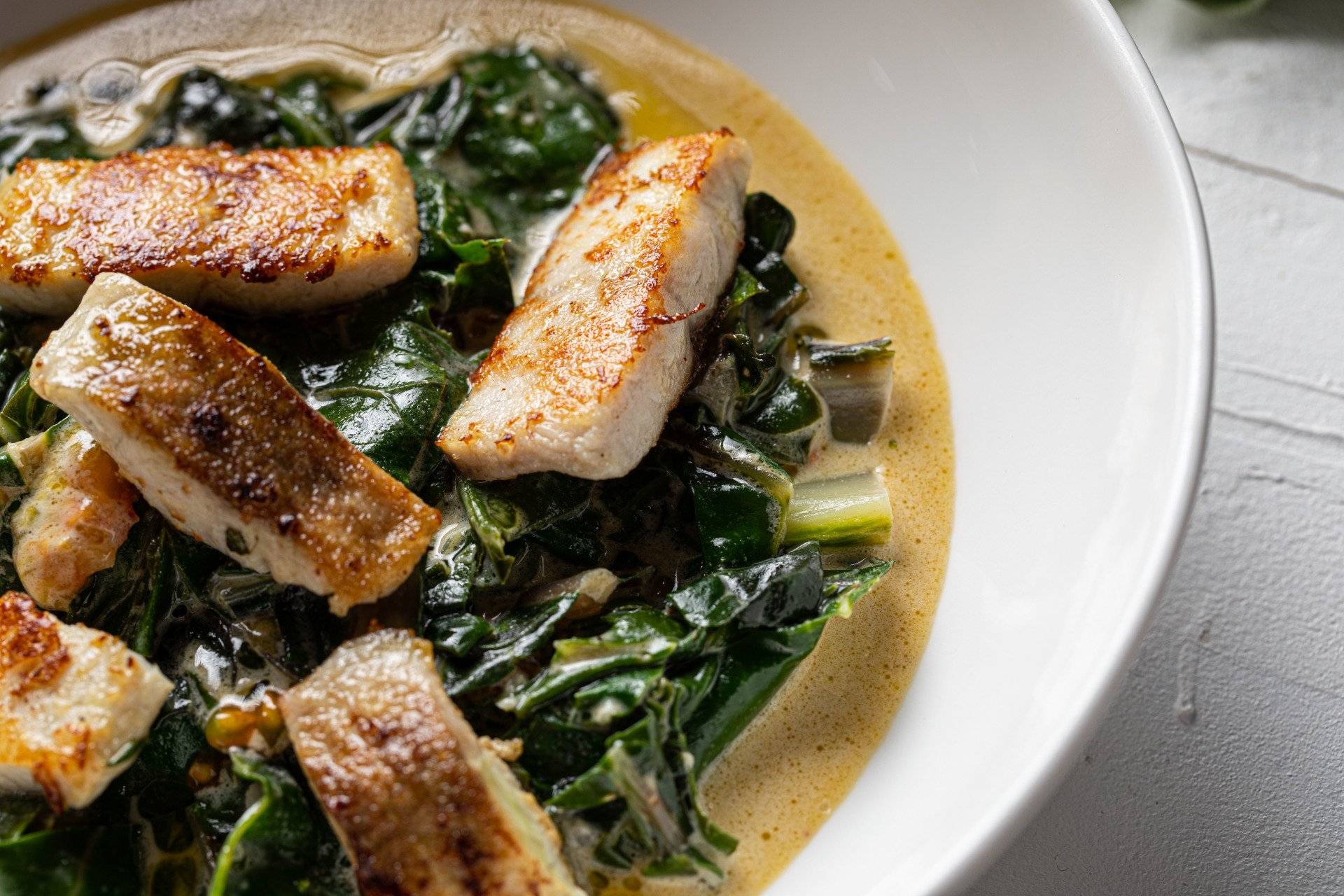 Grilled fish with spinach, preserved lemon and tahini