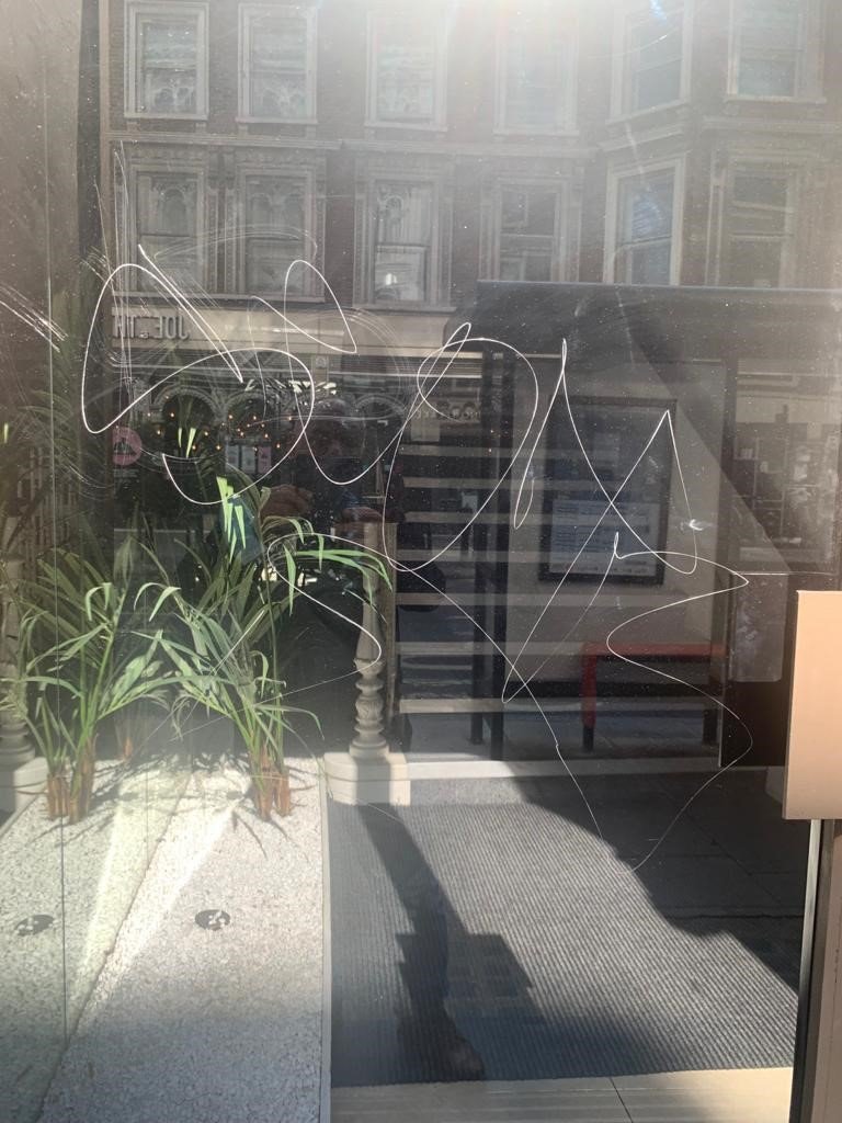Scratched glass graffiti removal in London