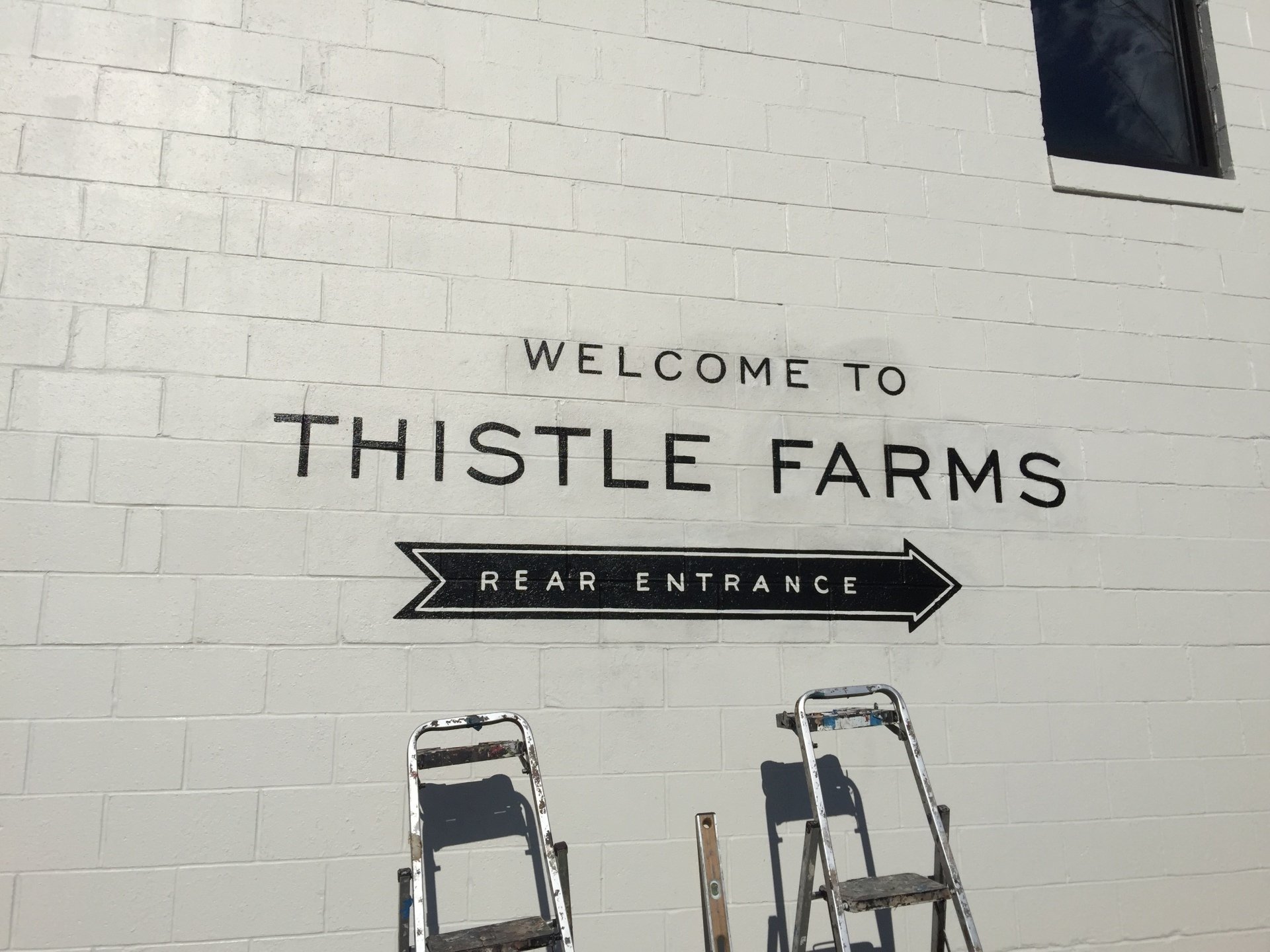 Mural Artist Paints Exterior Wall at Thistle Farms in Nashville TN