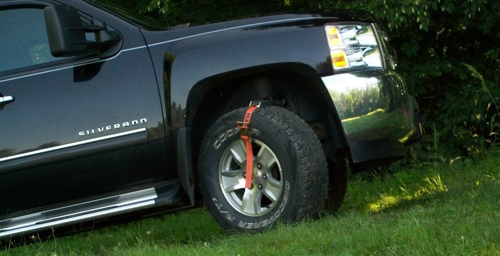 Strap on tire traction device for mud snow and sand